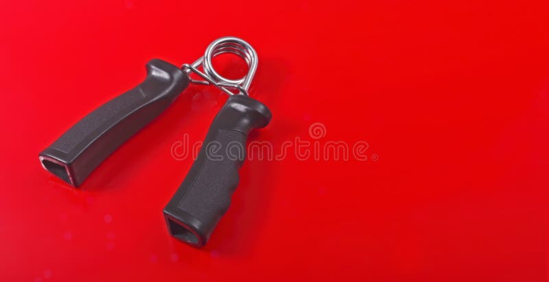 Hand Exercise Gripper Isolated on Red Background. Stock Image - Image ...