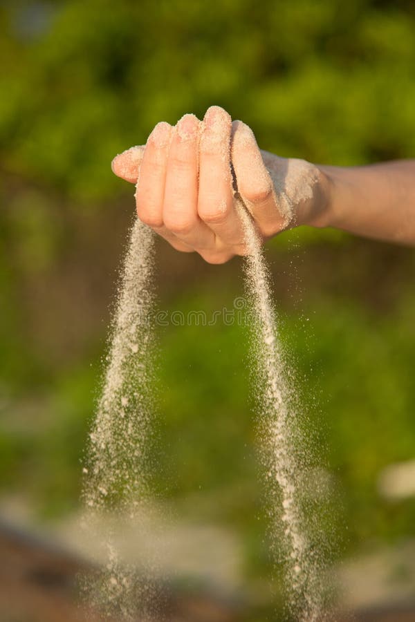 Hand with Falling Sand with Green Background Stock Photo - Image of ...