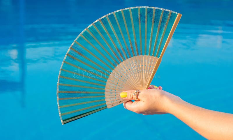 Hand Fan in Girls Hand by the Pool Stock Photo - Image of open, holding ...
