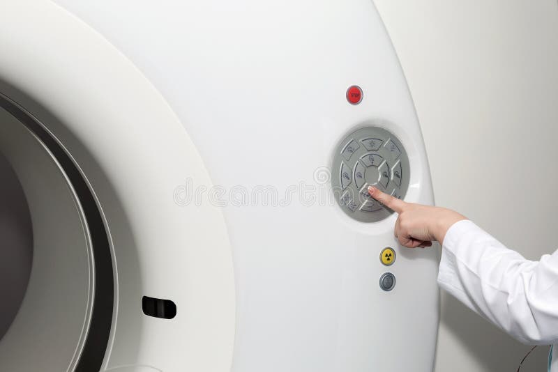 A Hand of Female Doctor Pushing Control Button on CT Scanner ...