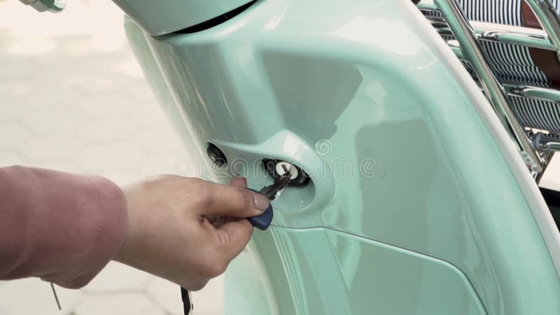 Hand of Female Inserts Scooter Key To Start Engine, Handheld View Stock ...