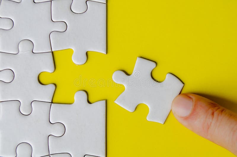 Hand Fitting a Missing White Jigsaw Pieces Stock Photo - Image of ...