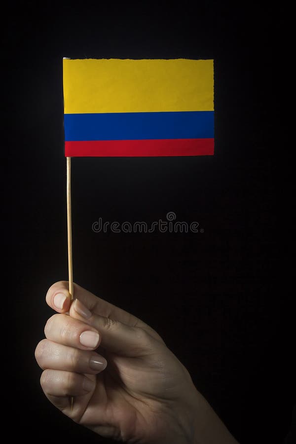 Hand with flag of Colombia stock image. Image of yellow - 167014641