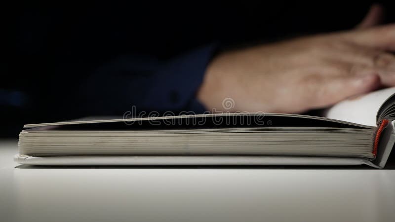 Hand Flipping through the Pages of an Open Book. Man Reading and ...