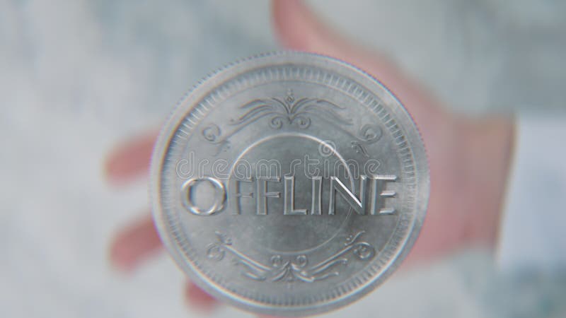 A Hand Flips a Coin Marked Online and Offline, Spinning Toward the ...