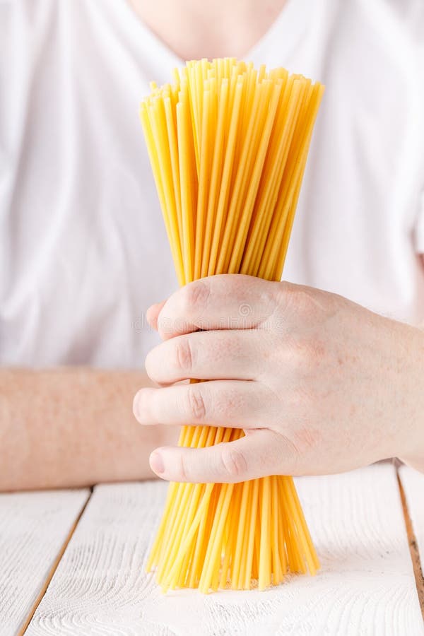 Hand Full of Raw Dry Spaghetti, Close Up View Stock Image - Image of ...