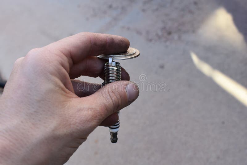 Hand Gapping a Spark Plug with Tool in the Driveway Stock Photo - Image ...