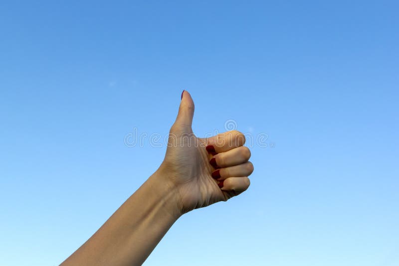 Hand Gesturing Thumbs Up Showing Good or Ok on Blue Sky Background ...
