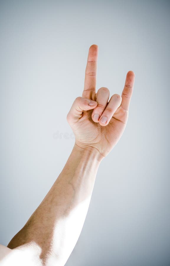 Hand Giving the Devil Horns Gesture Stock Photo - Image of body, human ...