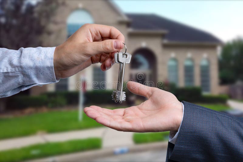 A Hand Giving a Key To Another Hand. House in the Background. Stock ...
