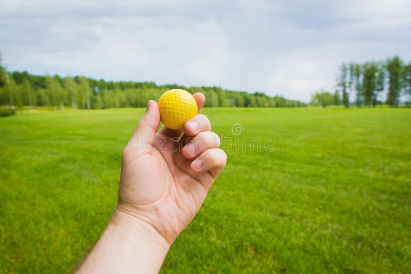 Hand with Golf Ball Over a Golf Course Stock Photo - Image of detail ...