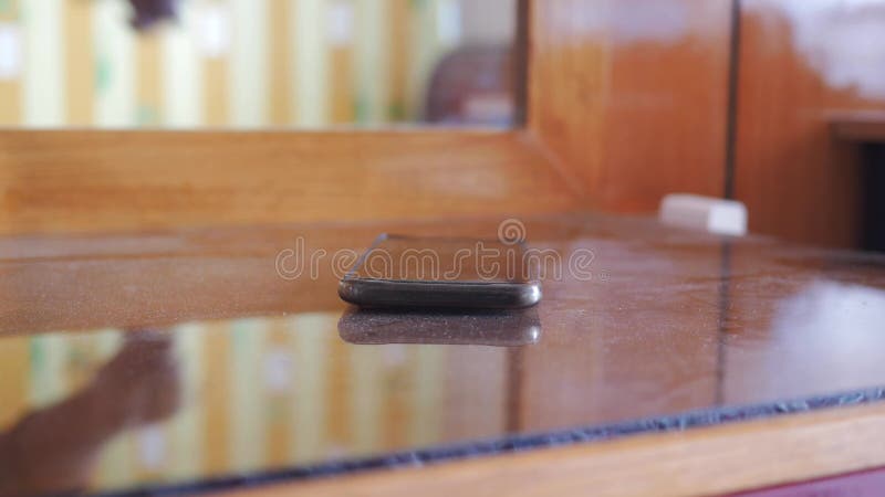 A Hand Grabbing and Picking Up Mobile Phone on the Table. Stock Footage ...