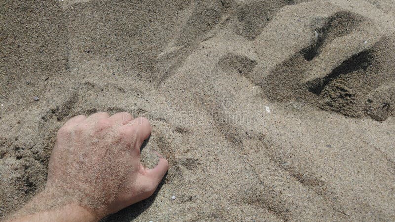 Hand Grabbing Sand on a Sunny Day Stock Photo - Image of sunny, sand ...