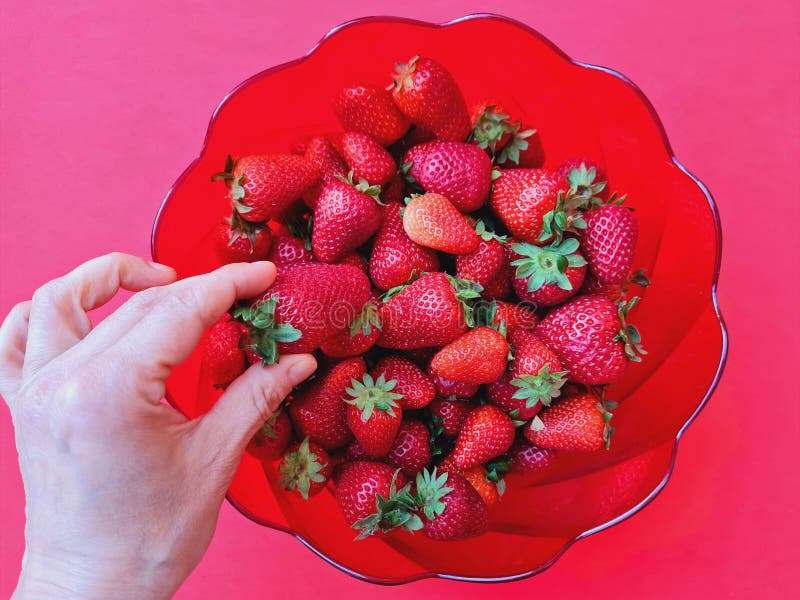 Hand Grabs a Strawberry Inside a Red Container Full of Strawberries ...