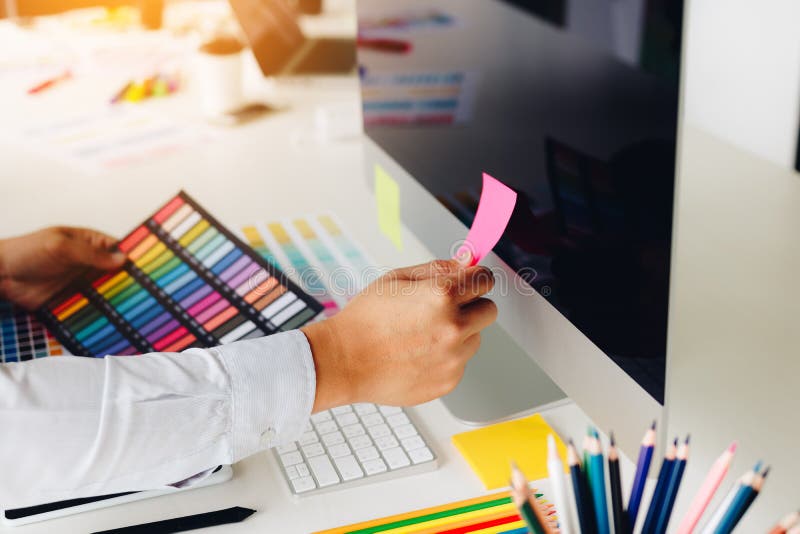 Hand of Graphic Designer Men are Sticking the Sticker on the Computer ...