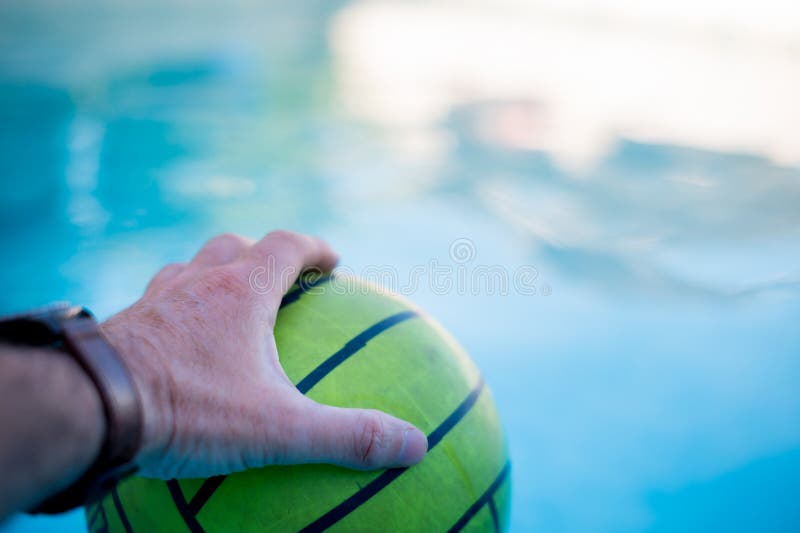 Hand Grasping a Rubber Ball in the Water Stock Photo - Image of ...