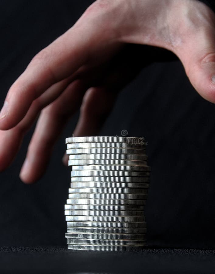 Hand Grasping for a Stack of Silver Coins Stock Photo - Image of ...