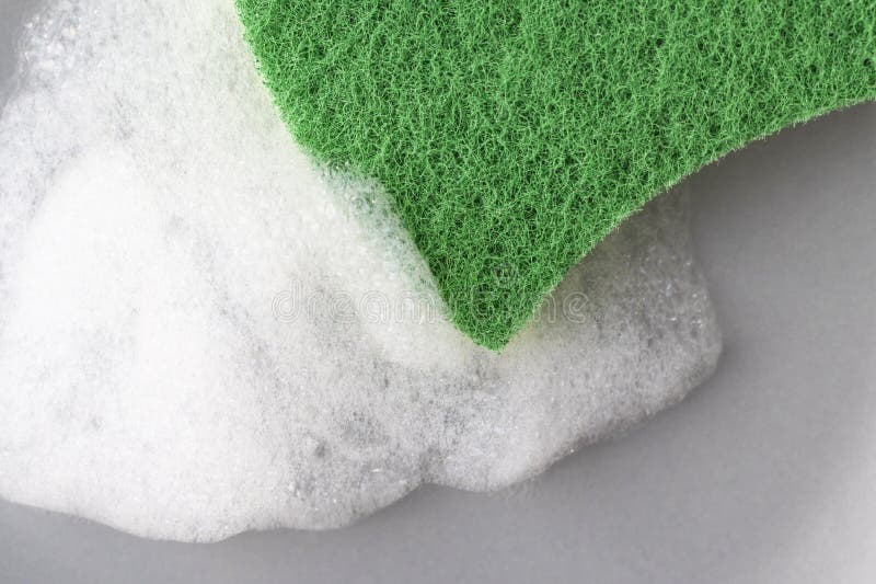 A Hand with a Green Sponge Washes a Gray Ceramic Plate Stock Photo ...