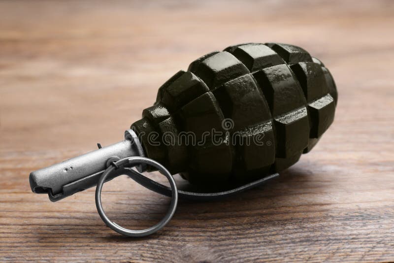Hand Grenade on Wooden Table, Closeup. Explosive Weapon Stock Image ...