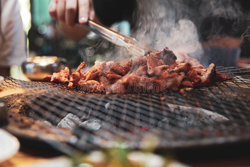 Hand Grilling a Korean Barbecue Ribs Meat with Smoke Stock Image ...