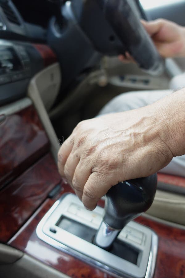 Hand Gripping Gear Shift while Driving in a Modern Vehicle Stock Photo ...