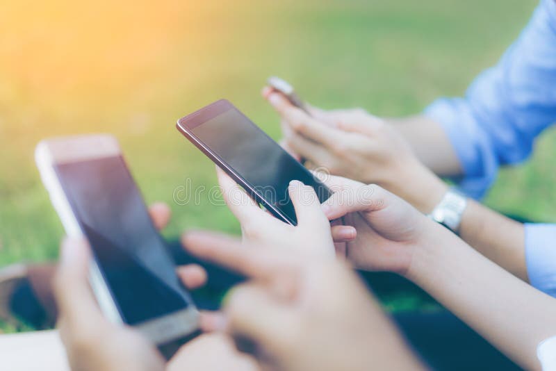 Group of Millennial Business People Using Mobile Phones and Sitting on ...