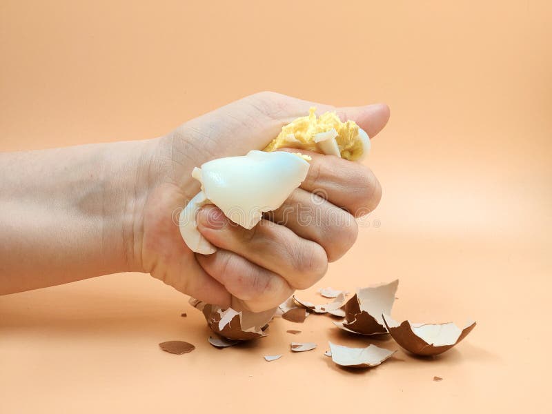 The Hand Has Crushed the Hard Boiled Egg, the Yolk and White Crumble ...