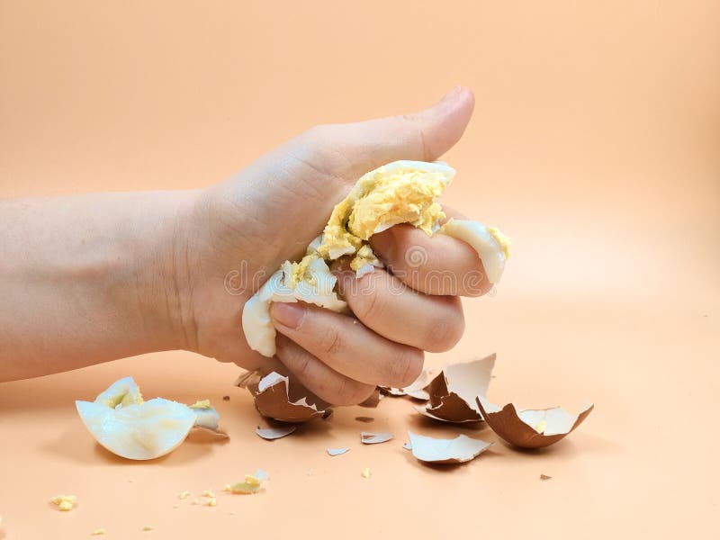 The Hand Has Crushed the Hard Boiled Egg, the Yolk and White Crumble ...