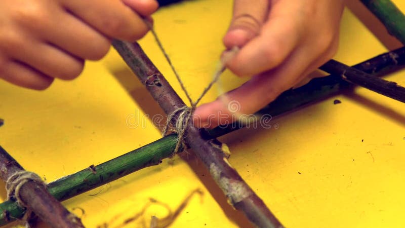 Boy with String Ties Knots, Ties Branches, Makes a Decoration Stock ...