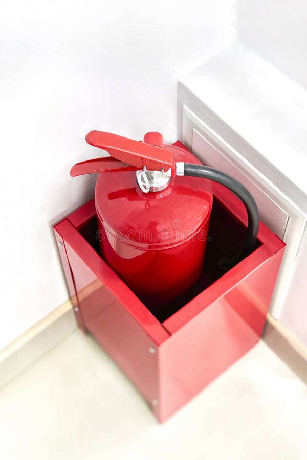 Hand-held Fire Extinguisher Stands in the Corner of the Office. Red ...