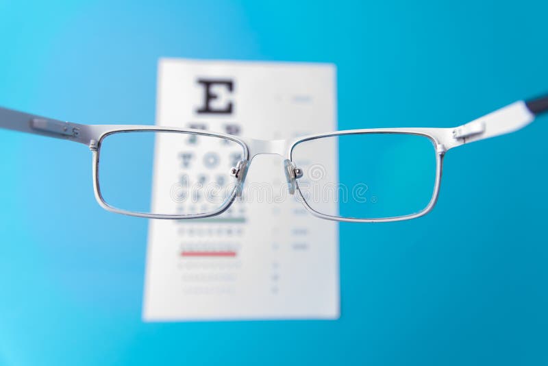 Hand-held Glasses, View of the Snellen Chart. Blue Background Stock ...