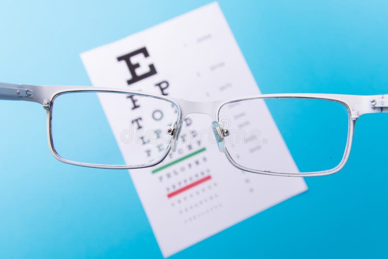 Hand-held Glasses, View of the Snellen Chart. Blue Background Stock ...