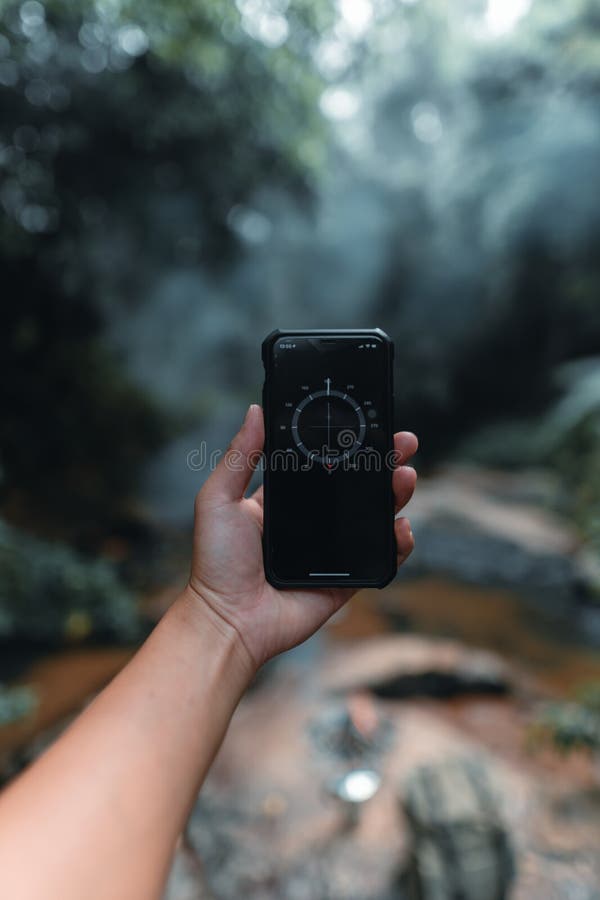 Hand Held Smartphone in Forest and Compass Stock Image - Image of ...