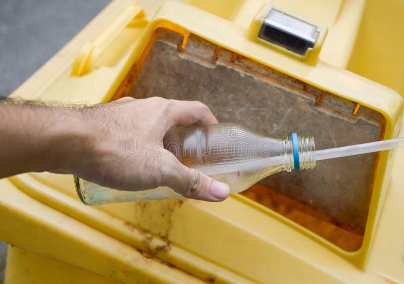 Hand Hold Glass Bottle on Yellow Bin Stock Image - Image of disposal ...