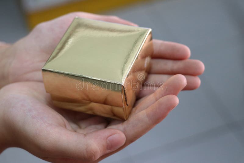 Hand hold gold square box stock image. Image of hand - 98225057