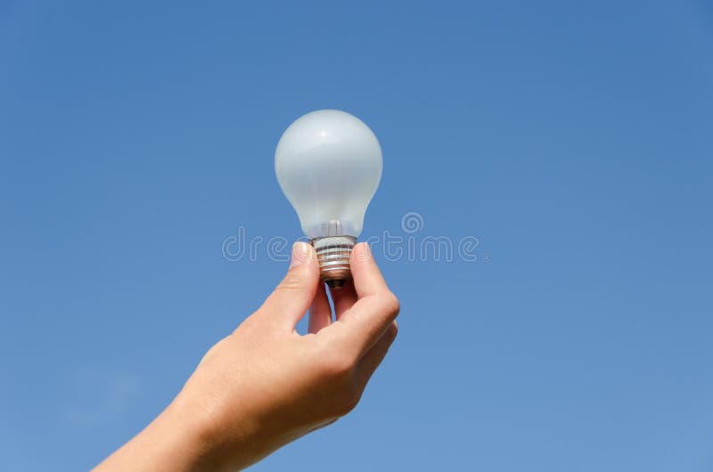 Hand Hold Light Bulb on Blue Sky Background Stock Photo - Image of ...