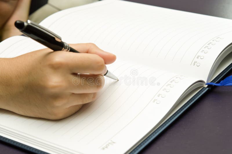 Hand Hold a Pen and Write on a Book Stock Photo - Image of education ...