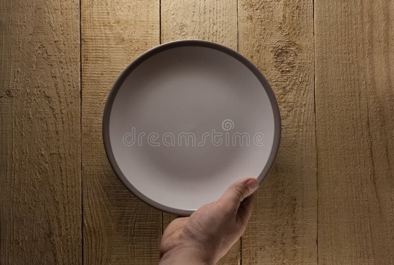 Hand hold plate on wood stock photo. Image of fork, male - 92351186