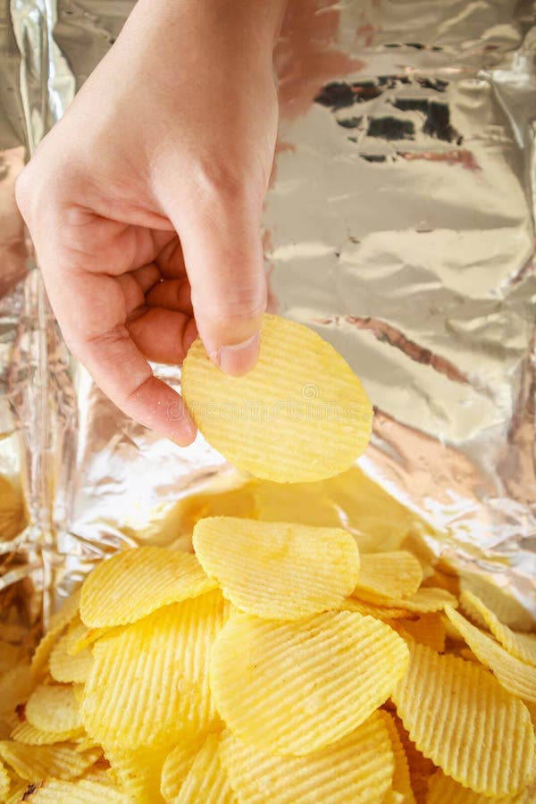 Hand Hold Potato Chips Inside Snack Foil Bag Stock Image - Image of ...