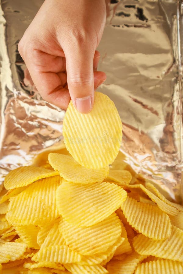 Hand Hold Potato Chips Inside Snack Foil Bag Stock Image - Image of ...