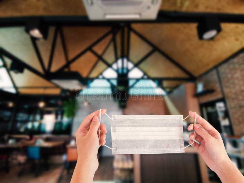 Hand Hold Protective Face Mask on a Coffee Shop Stock Image - Image of ...