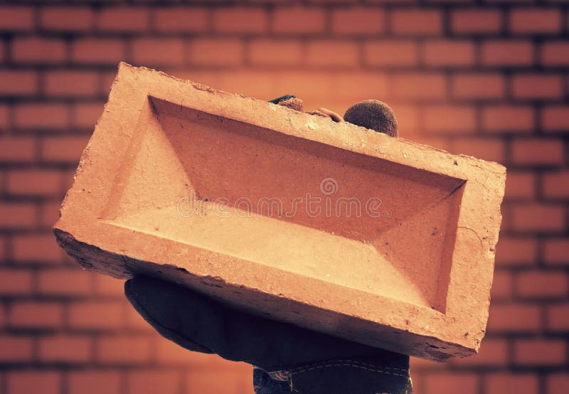 Hand hold red brick stock image. Image of development - 175790163