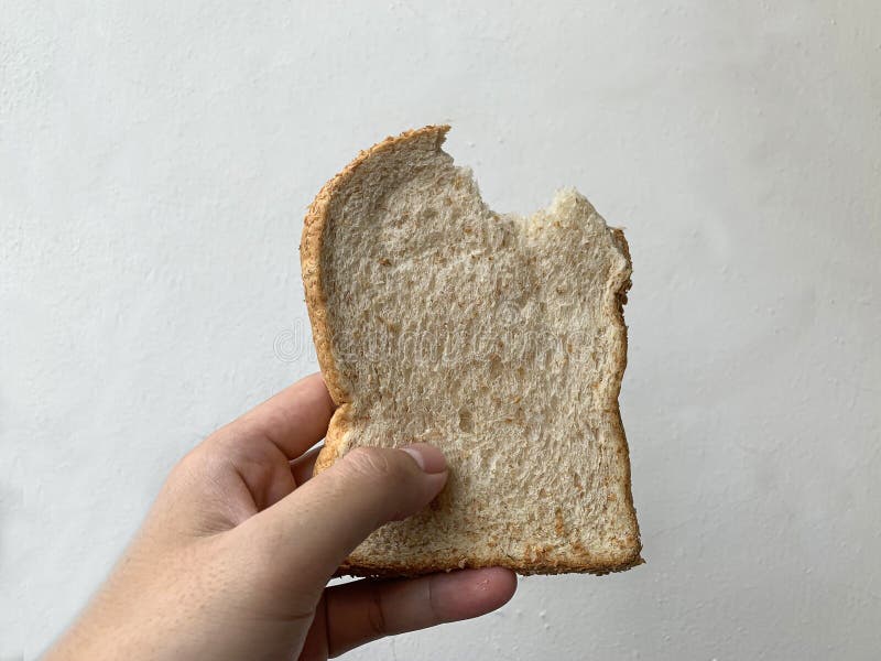 Hand Hold Slices of Bread with Bite Marks on White Background Stock ...