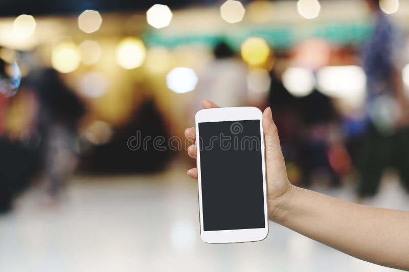 Hand Hold and Touch Screen with Blur Shopping Mall Stock Image - Image ...