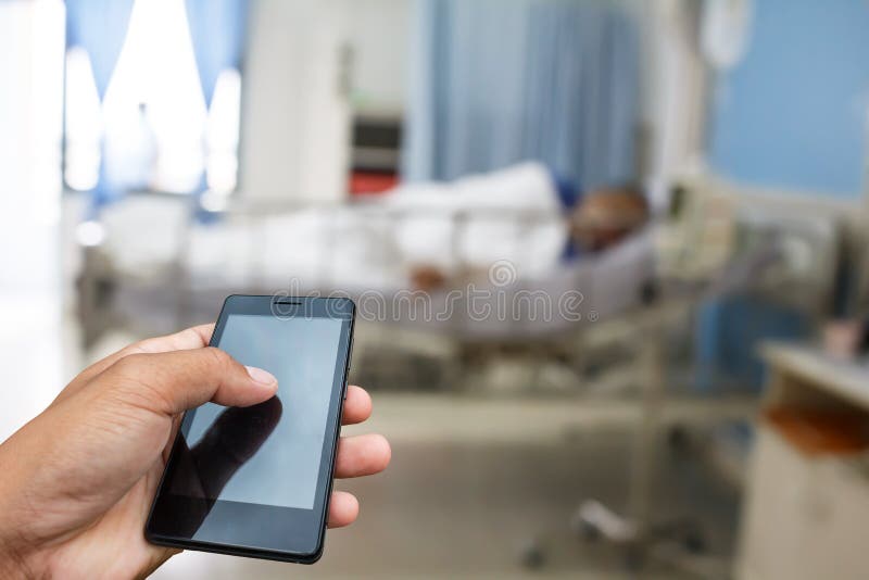 Hand Hold and Touch Screen Smart Phone, on Blur Image of a Patient in ...