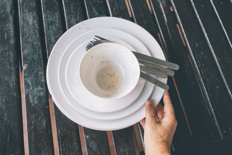 Hand Hold Used White Bowl and Plate with Fork and Spoon on Wooden Table ...