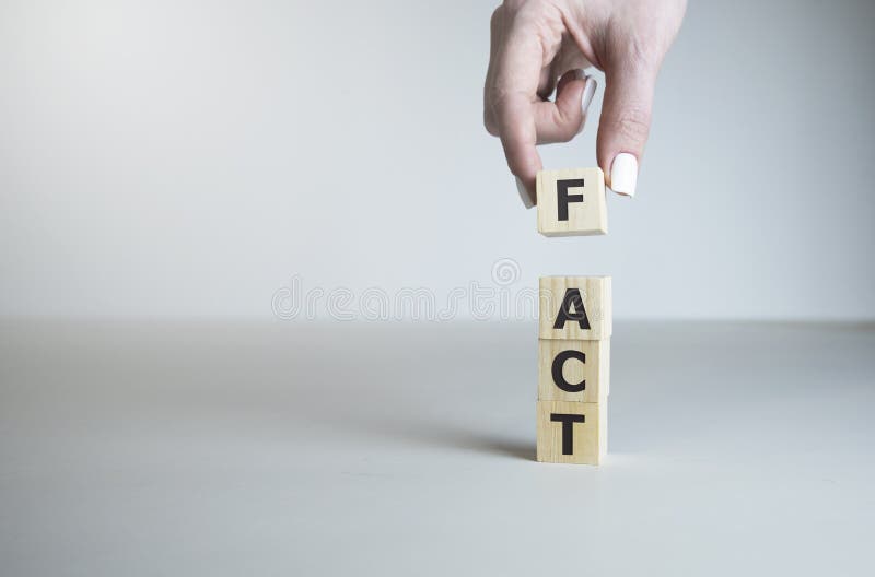 Hand Hold Wooden Cubes with Word FACT on Table. Cubes with Letters ...