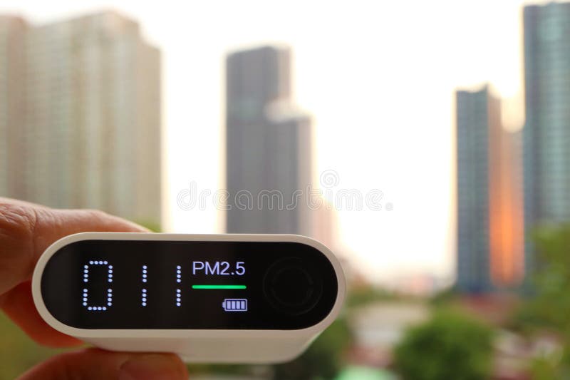 Hand Holding an Air Quality Sensor with Skyscrapers in the Backdrop ...