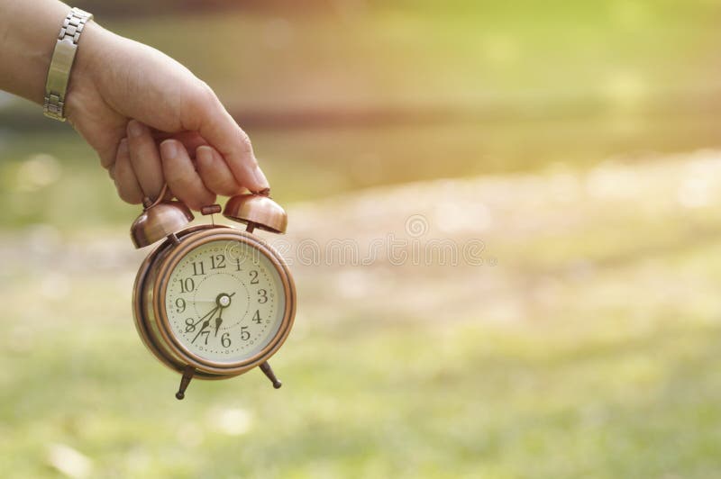 Hand holding alarm clock stock image. Image of style - 85000397