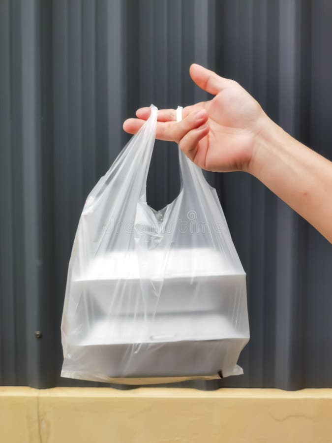 Hand Holding a Bag of Take Away Food in Polystyrene Container. Stock ...